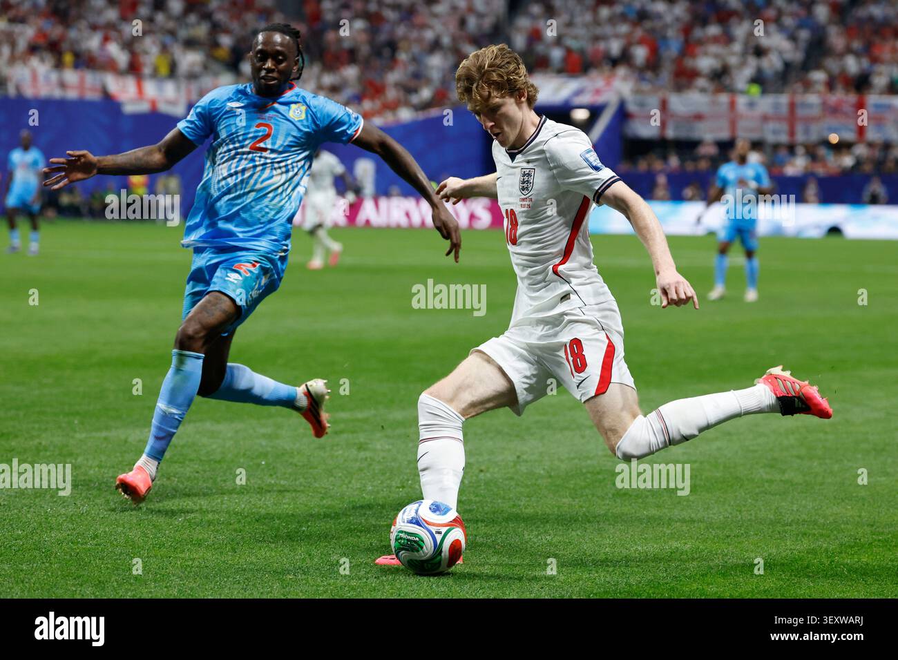 England's Anthony Gordon (18) kicks the ball next to Congo's Aaron Wan ...