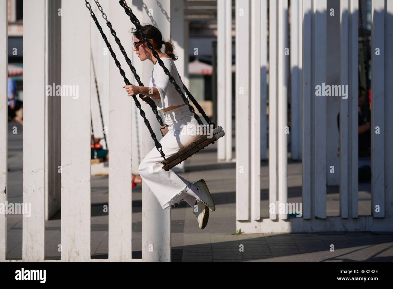 A woman rides on a swing on a hot summer day in Moscow, Wednesday, July ...
