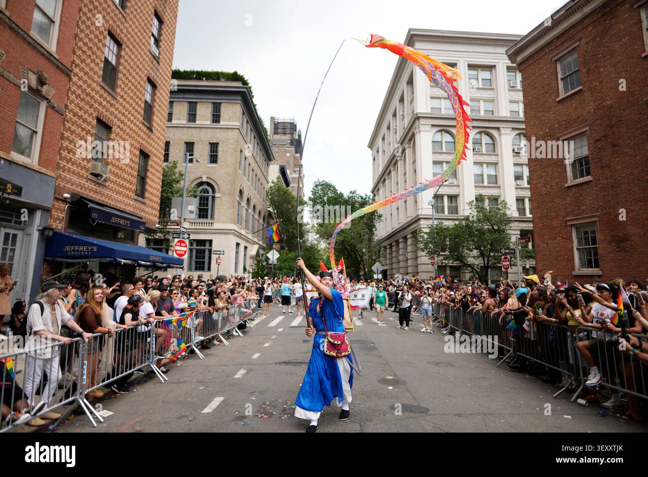 A parade-goer from the Chinese Rainbow Network with a Chinese dragon ...