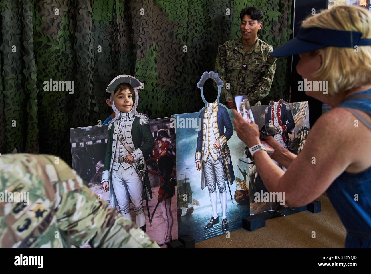 A boy poses for a photo by his grandmother inside the Defense ...