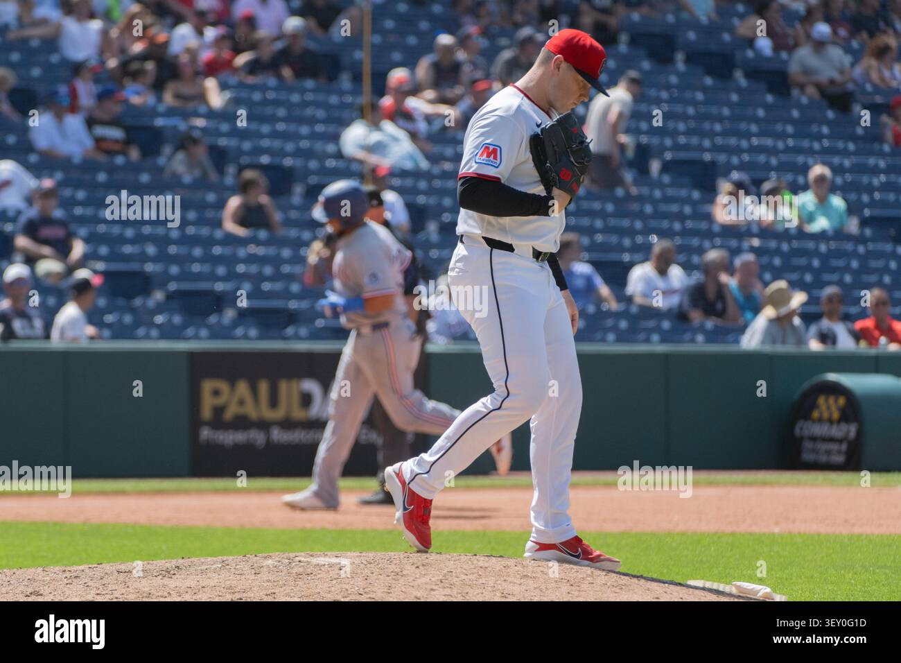 Cleveland Guardians relief pitcher Erik Sabrowski , foreground, walks ...