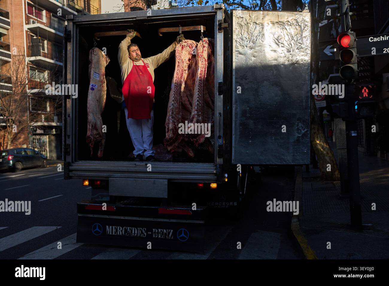 Jose Gomez waits for a coworker to unload beef carcasses at a butcher ...