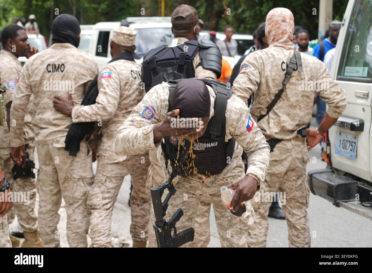 A police officer pours Coca-Cola on his face after police fired tear ...