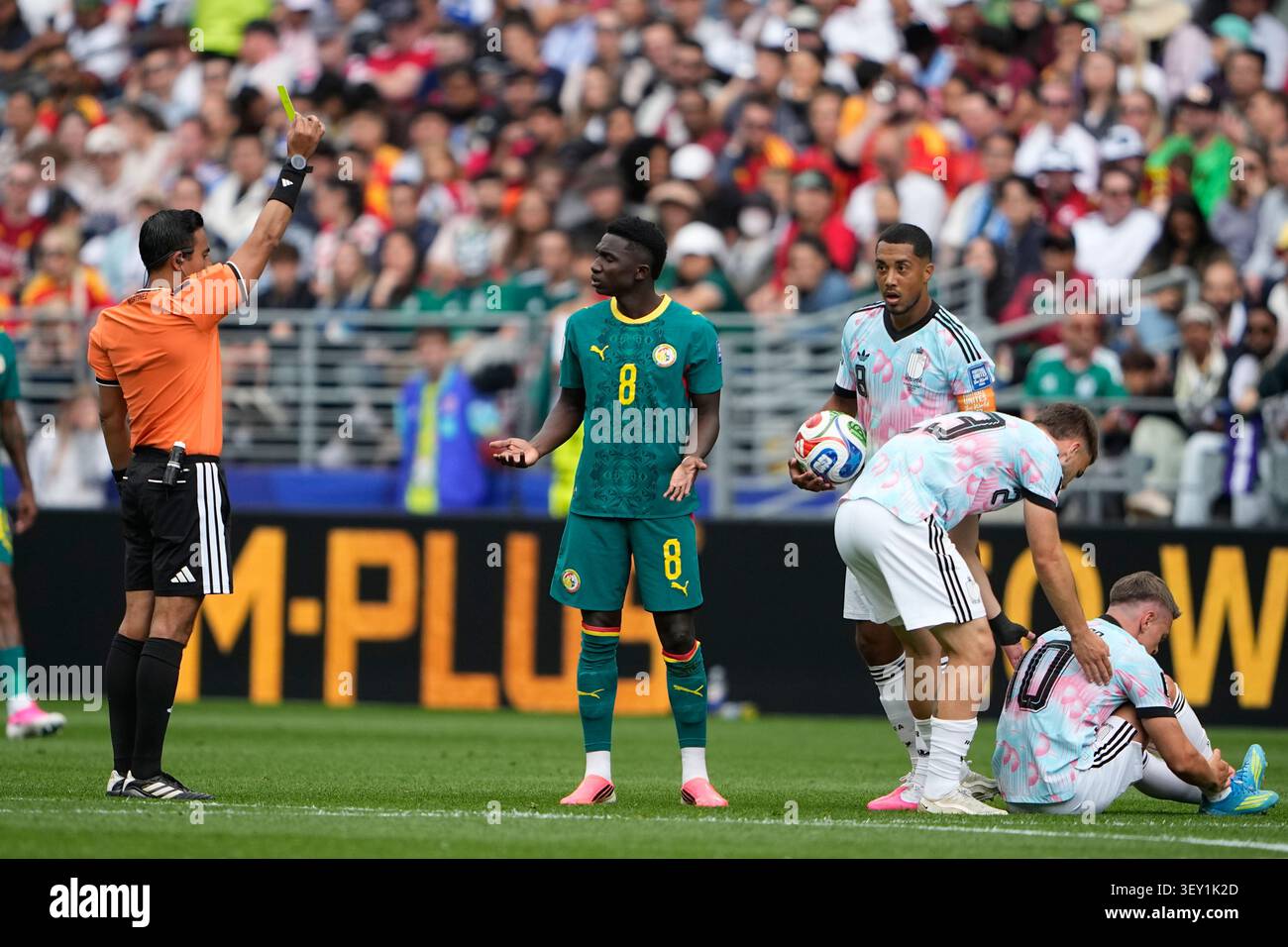 Senegal's Lamine Camara (8) receives a yellow card from the referee ...