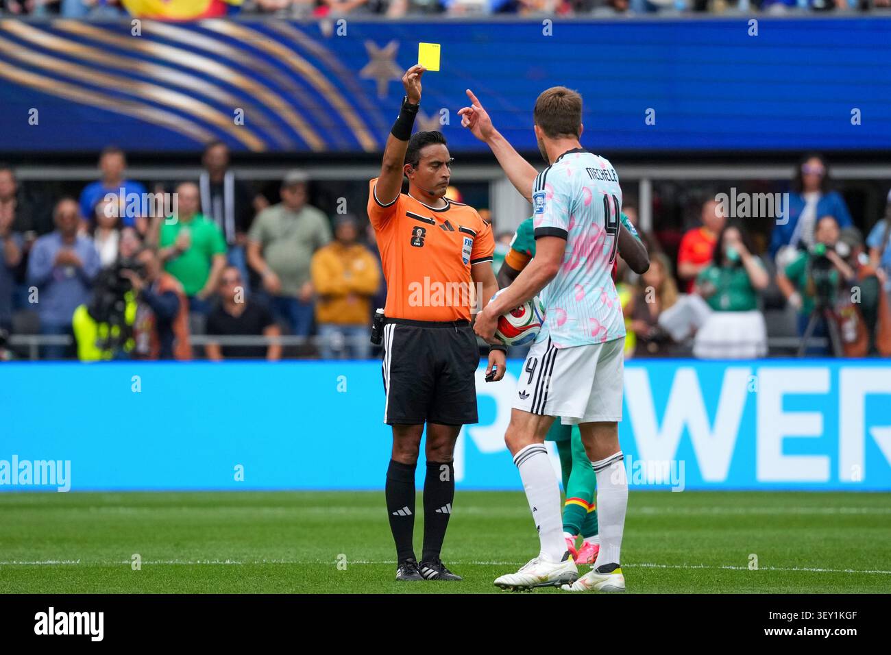 Belgium's Brandon Mechele (4) receives a yellow card from referee Said ...