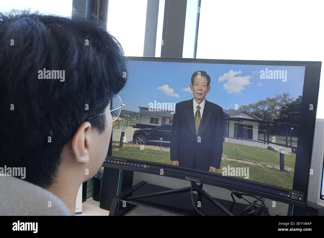 Lee Geon Hui looks at a computer screen as a video clip shows a digital ...