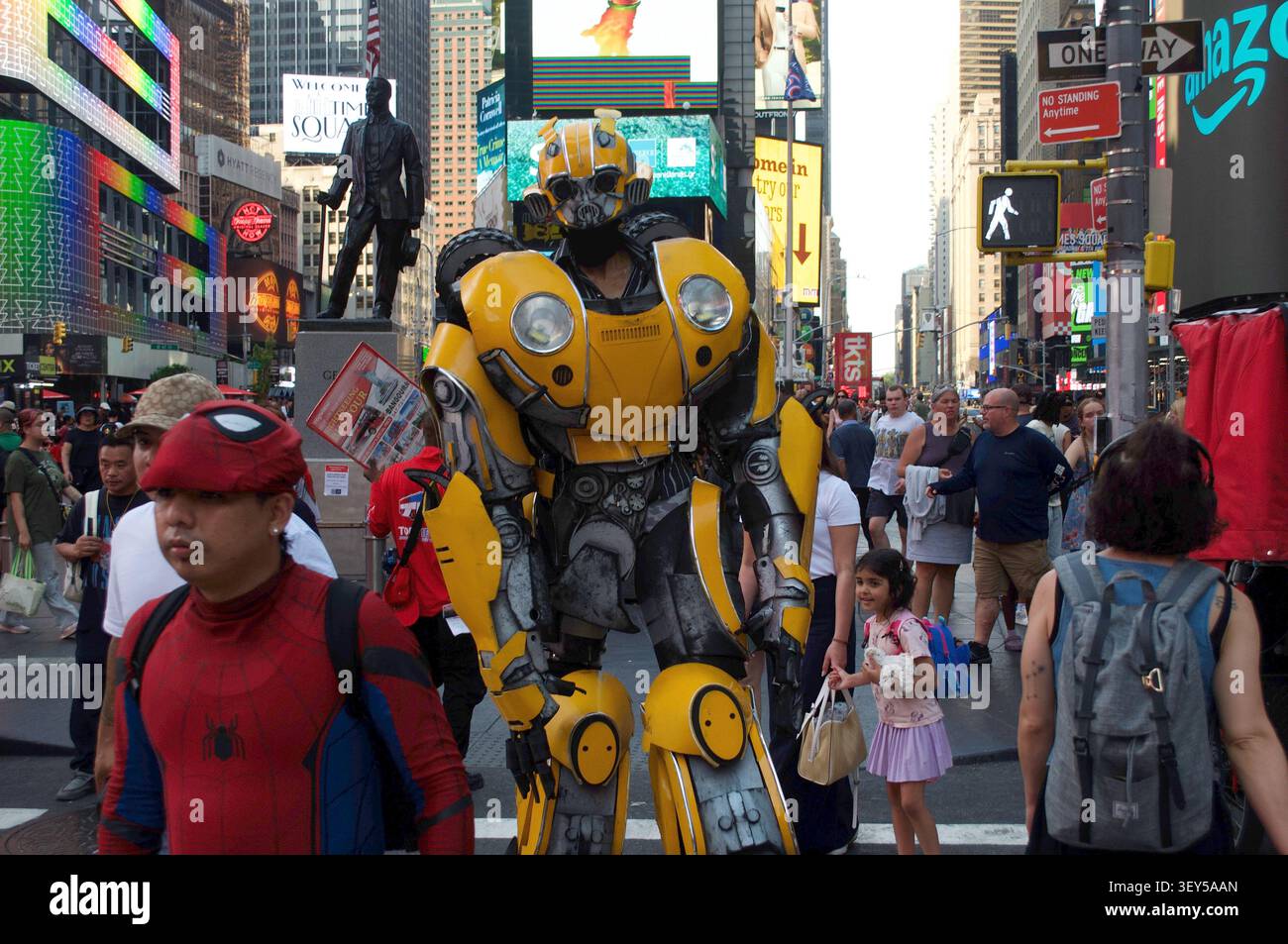 People wearing a Spiderman costume, left, and a Bumblebee costume ...