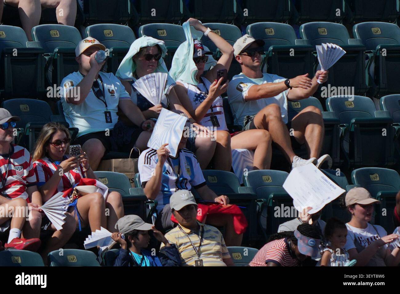 Fans protect for the sun before the World Cup round of 16 soccer match ...