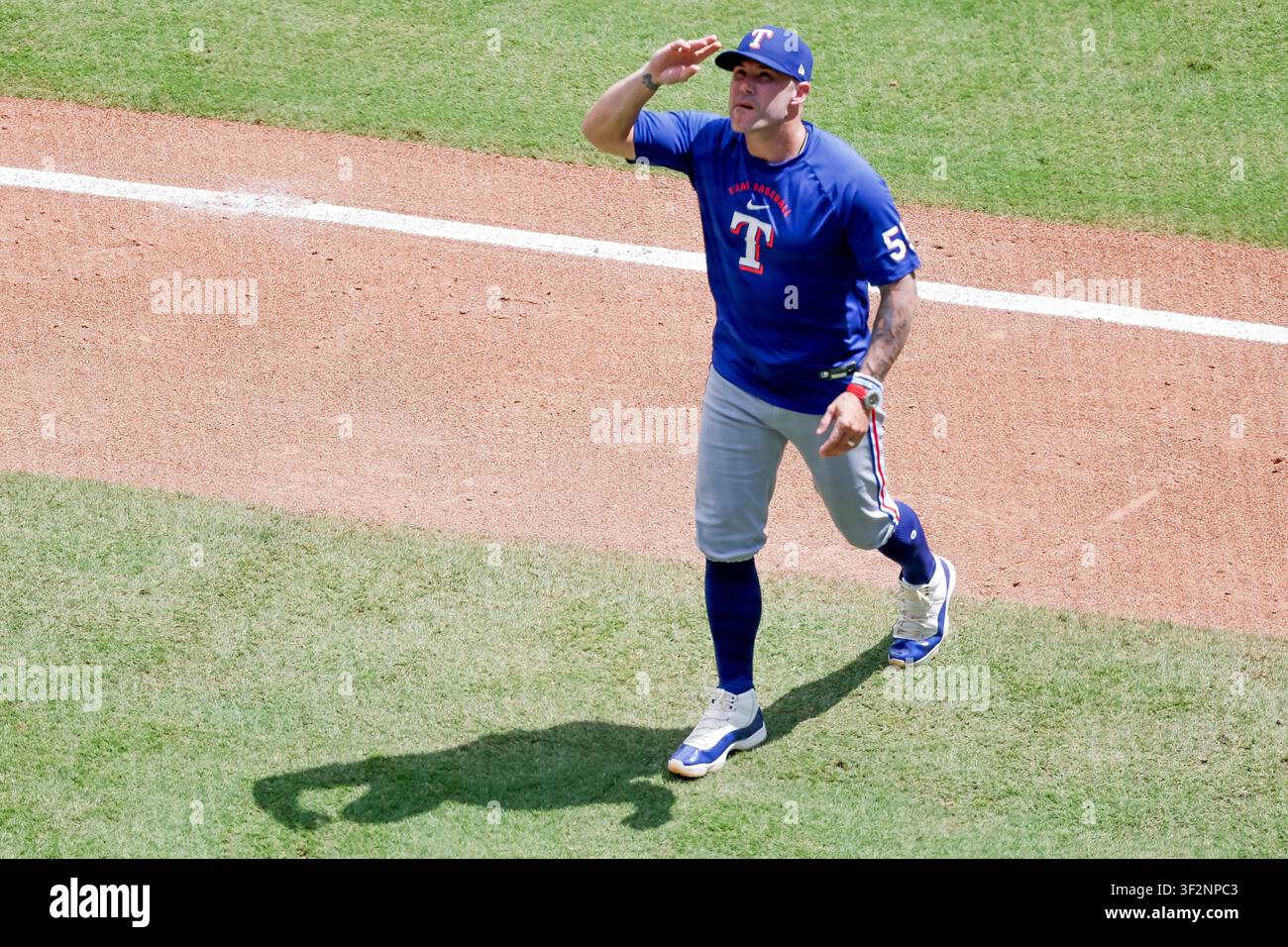 Texas Rangers manager Skip Schumaker walks back to the dugout after ...