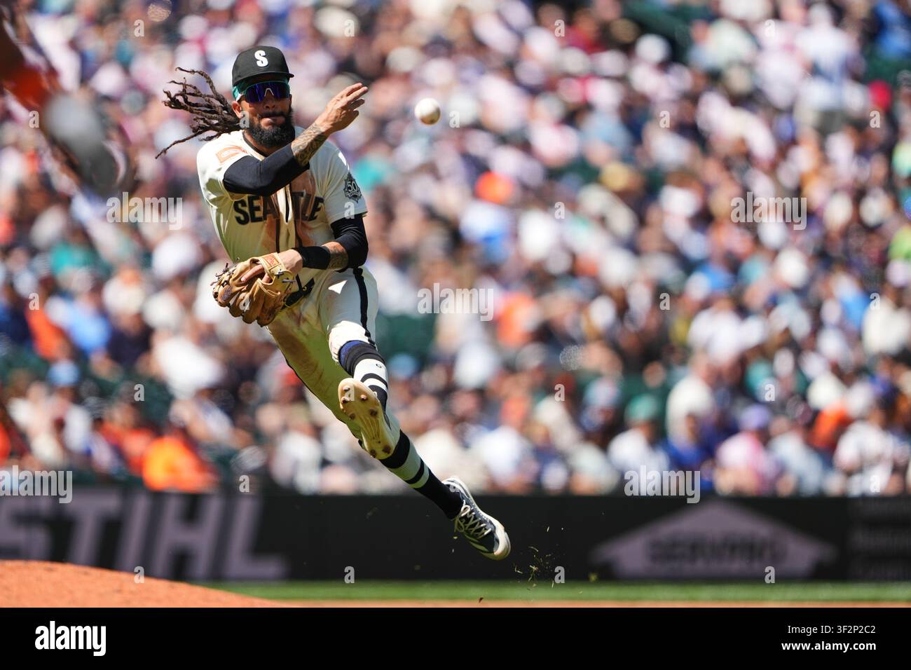 Seattle Mariners third baseman J.P. Crawford makes the throw to first ...