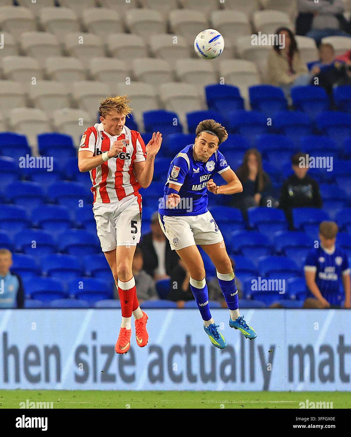 Stoke City's Luke Graham leaps with Cardiff City's Joel Colwill in the ...