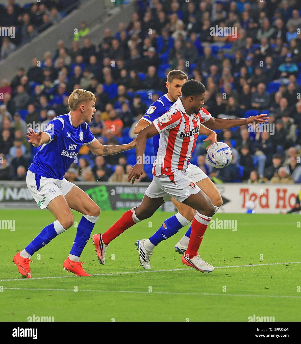 Stoke City's Ben Johnson outmuscles Cardiff City's Joel Bagan before ...
