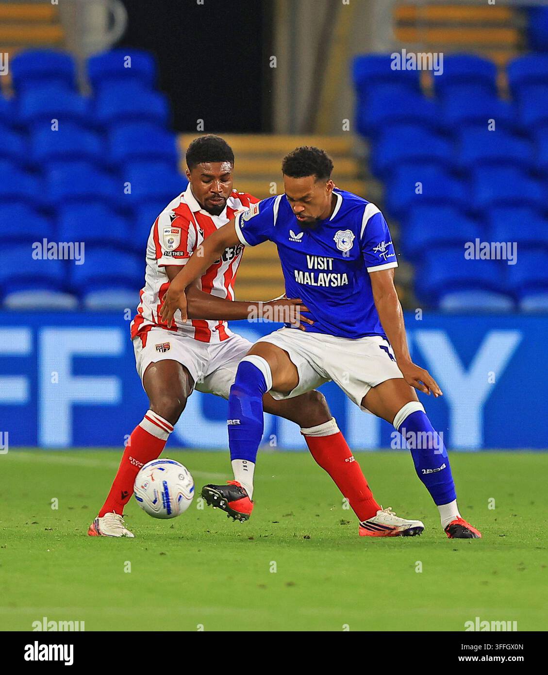 Cardiff City's Chris Willock holds off Stoke City's Ben Johnson in the ...