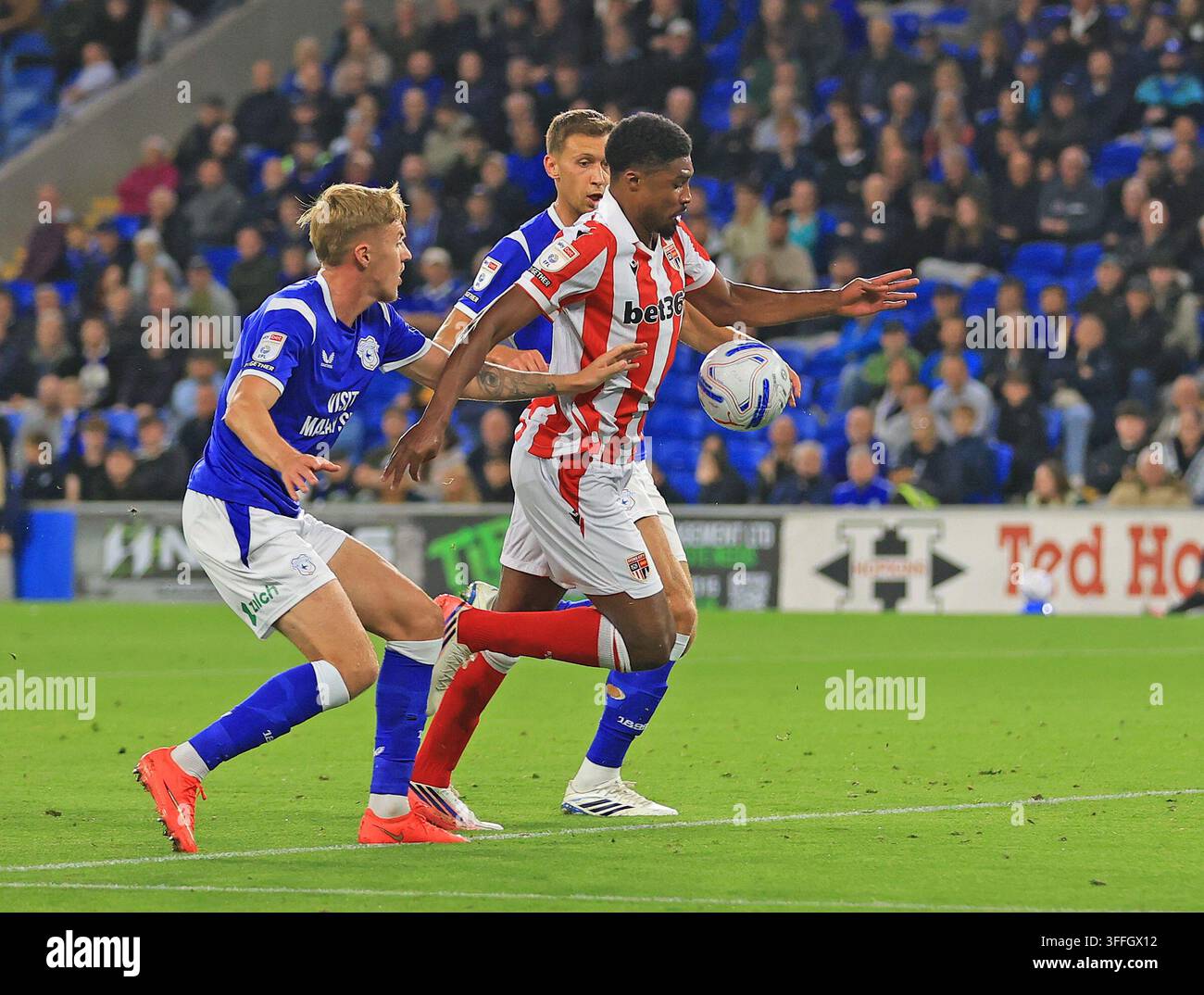 Stoke City's Ben Johnson outmuscles Cardiff City's Joel Bagan before ...