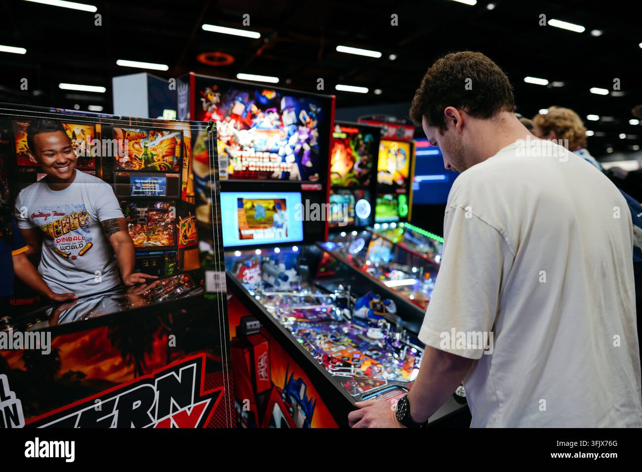 Cologne, Germany - August 26, 2026: Visitors play colorful pinball ...