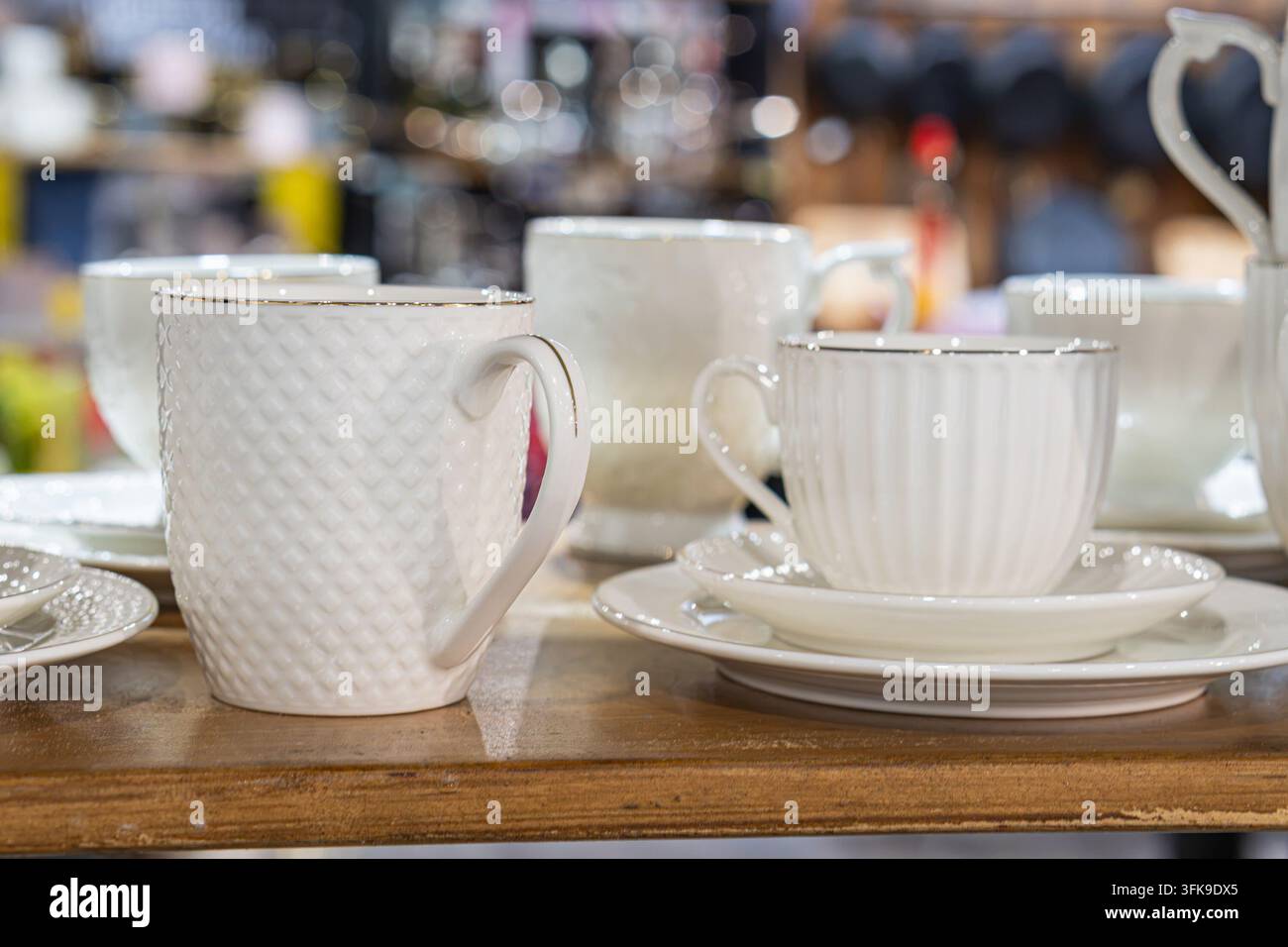 Elegant white ceramic tableware assortment featuring intricate designs ...