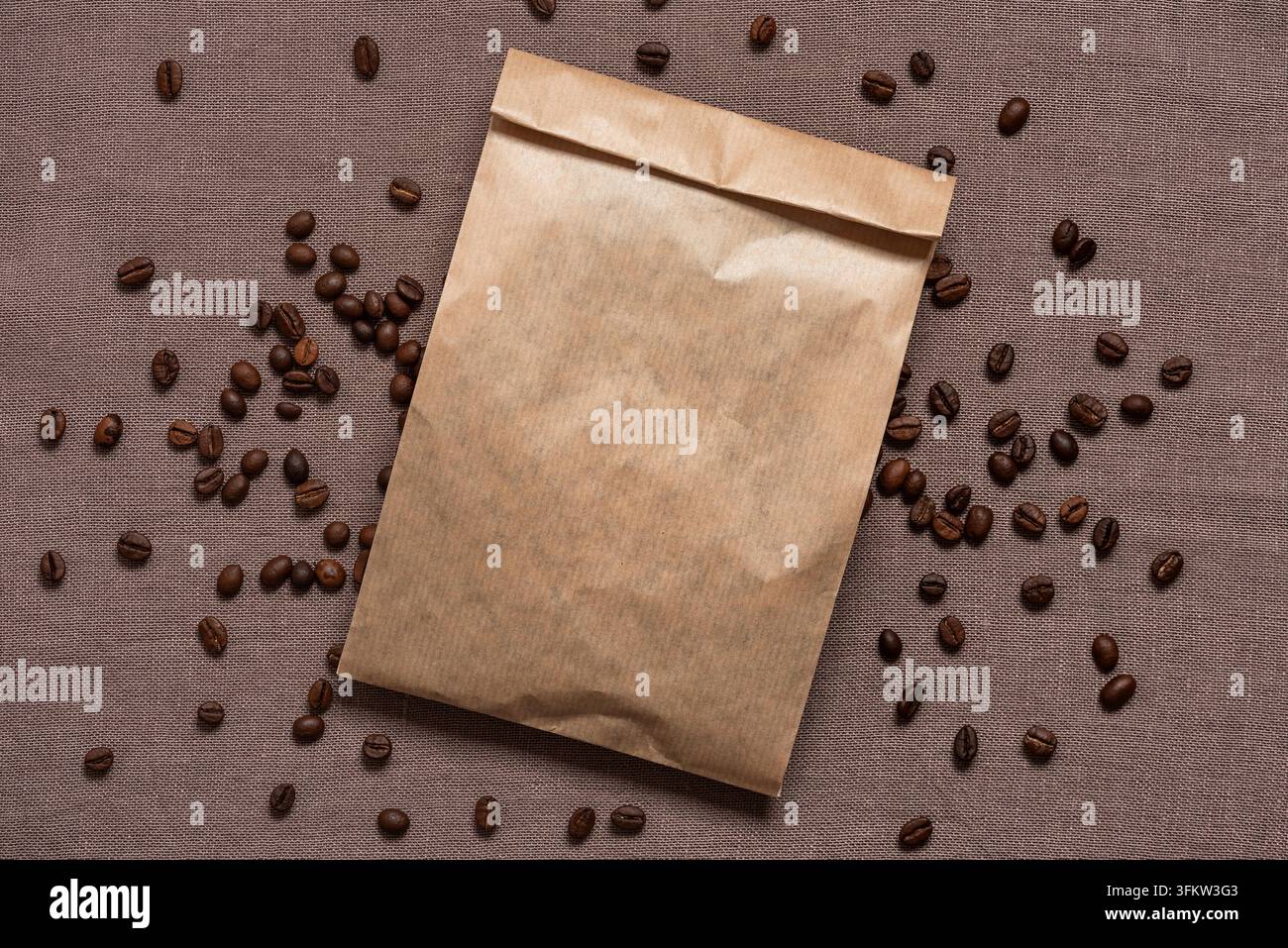 Brown paper bag mockup and roasted coffee beans flat lay on brown ...