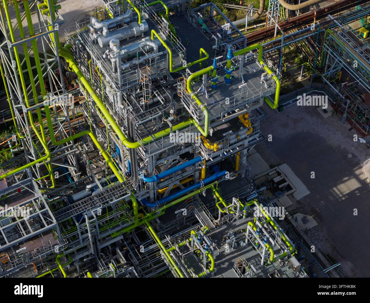 Aerial view of a chemical plant with complex industrial piping, steel ...