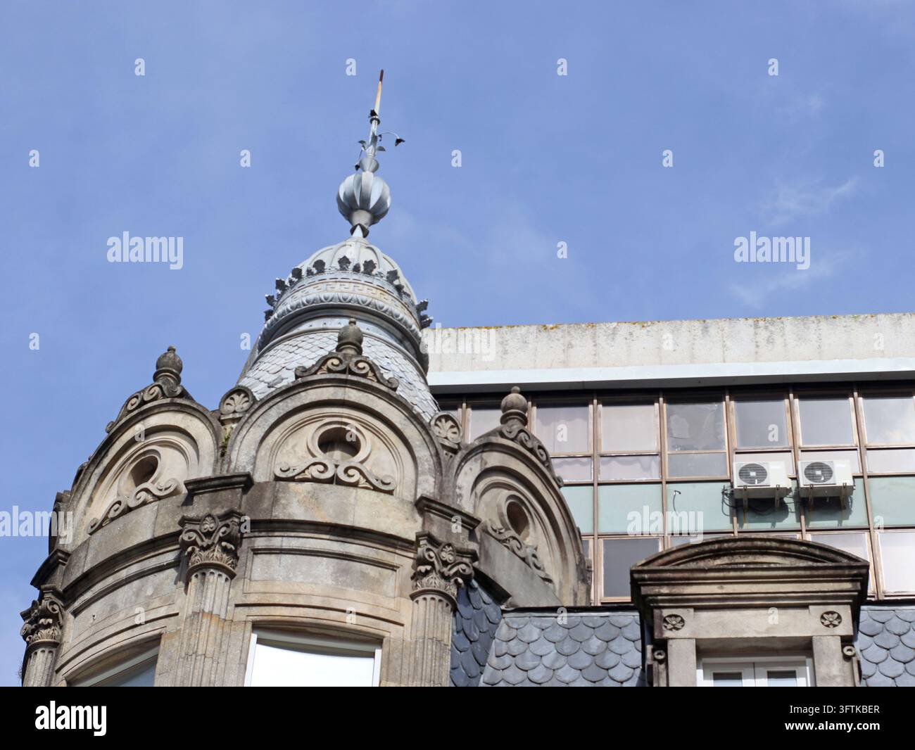 Ornate old stone building corner with decorative dome, spire, carved ...