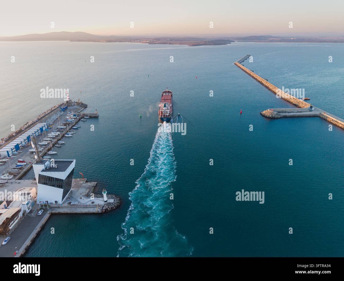 Aerial view of a cargo ship departing from the Port of Burgas, leaving ...