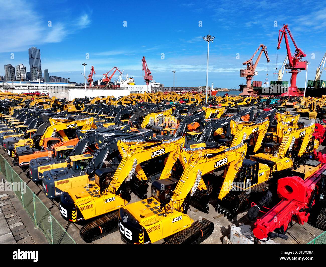 A cargo ship loads domestically-made engineering vehicles for export to ...