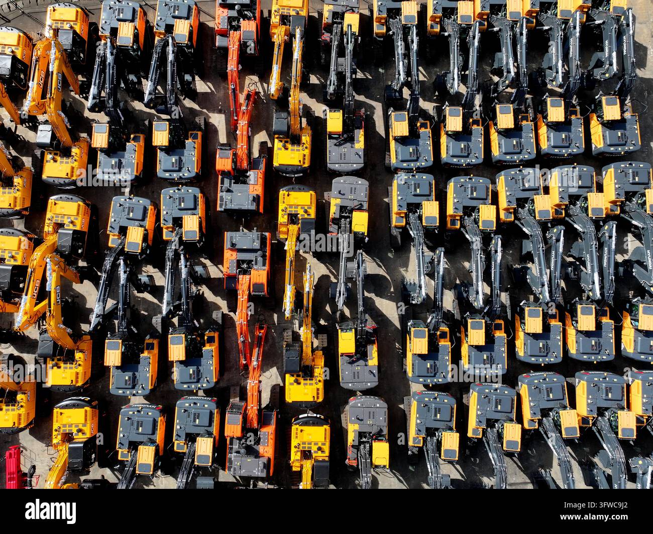 A cargo ship loads domestically-made engineering vehicles for export to ...