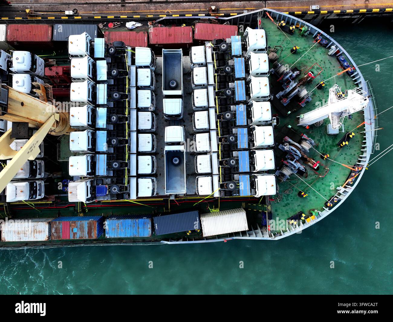 A cargo ship loads domestically-made engineering vehicles for export to ...