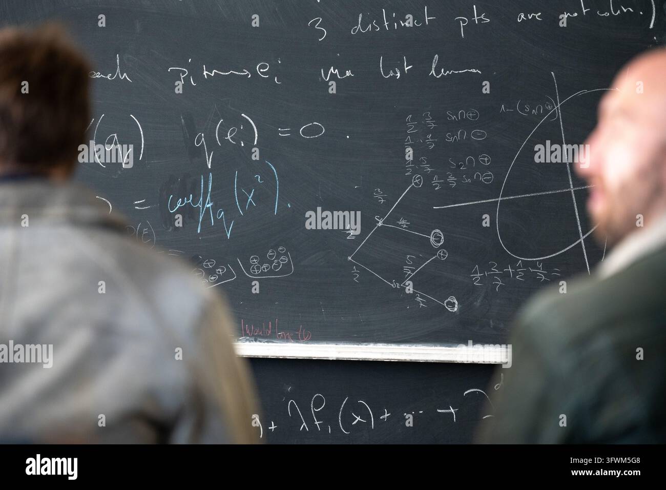PRODUCTION - 16 October 2026, Berlin: Two students are looking at a ...