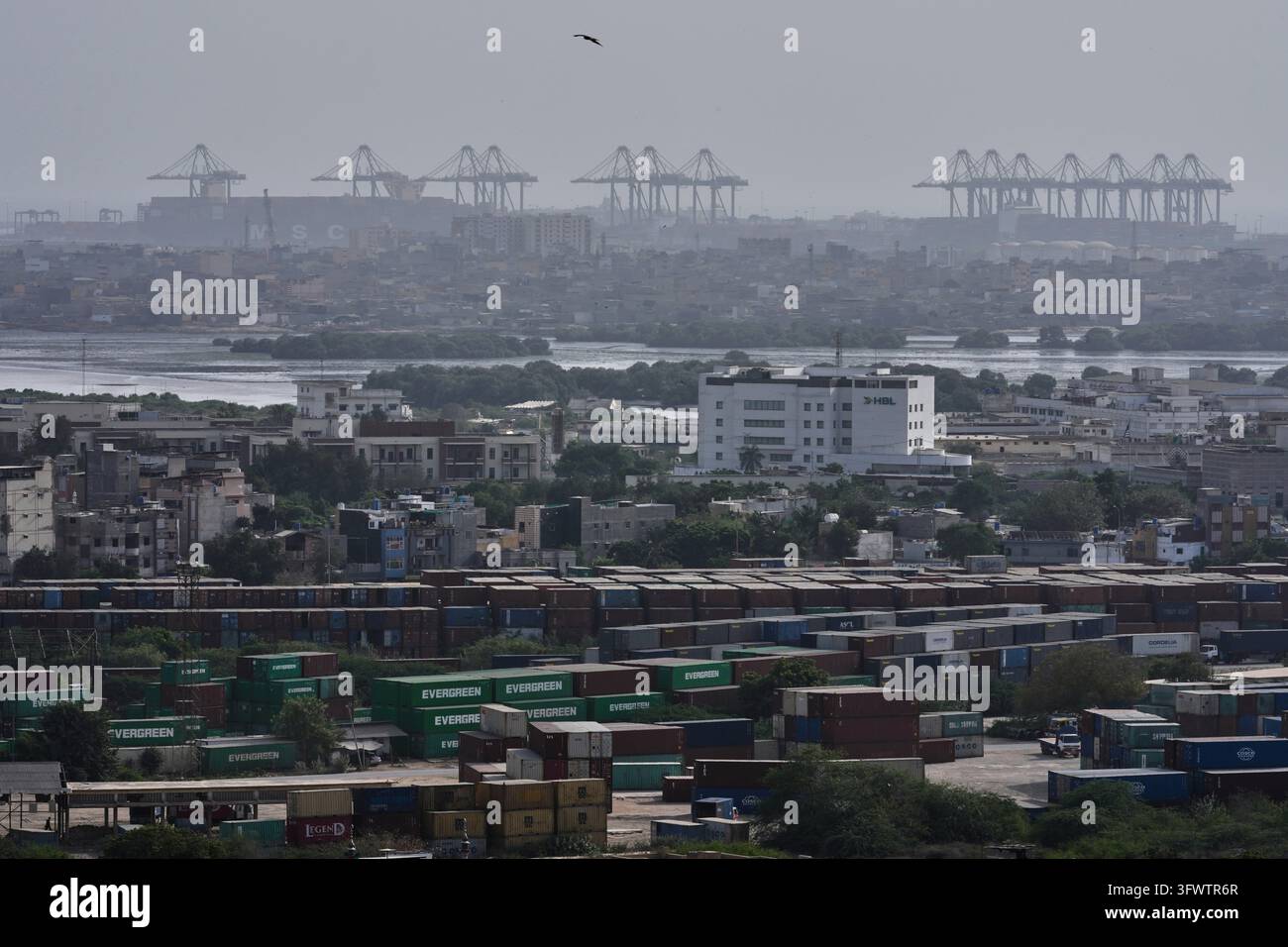 Shipping containers are visible at a port in Karachi, Pakistan ...