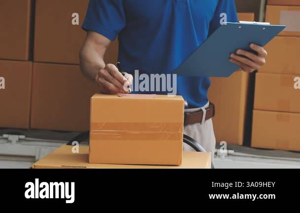 delivery man with cardboard box in office. delivery man working in a ...