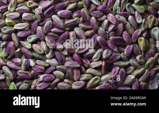 Pile pistachio kernels nuts without shell, rotates, close up ...