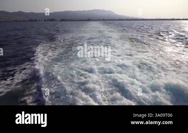 Blue ocean sea water wave with fast yacht boat wake foam of prop wash ...