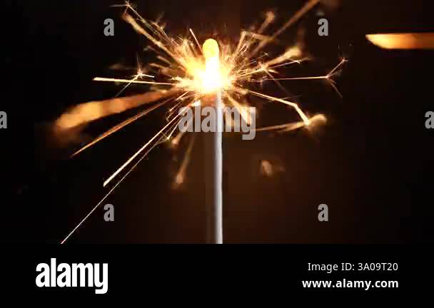 Burning sparkler on the black background, close up. Sparkler concept ...