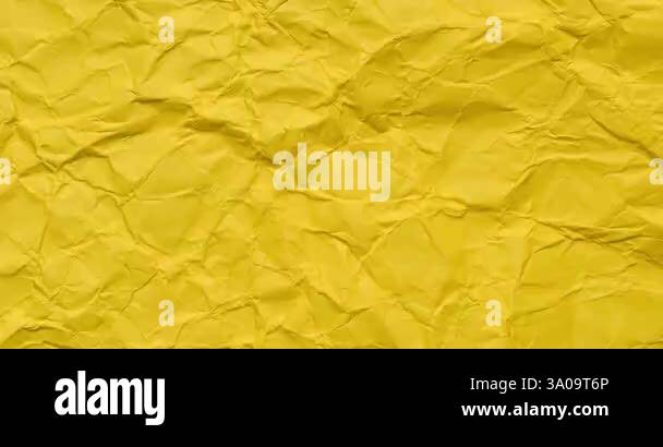 Video Top view of wrinkled textured bright yellow paper sheets that ...