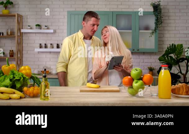 Family in the kitchen. Couple of man and woman in the morning at home ...