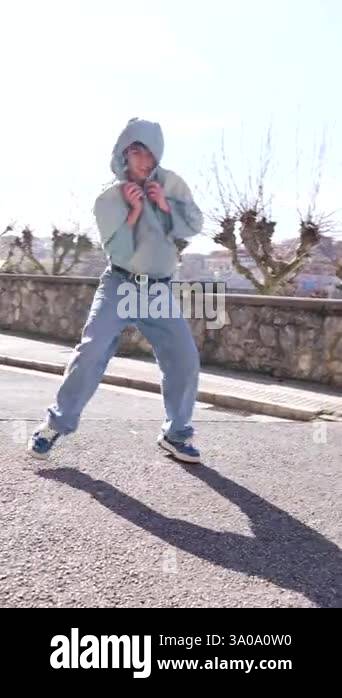 Confident young dancer performing dynamic freestyle moves, expressing ...