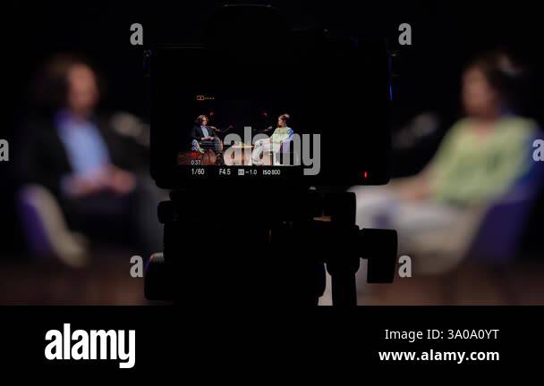 Backstage. In a cozy studio, a dynamic conversation unfolds between two ...