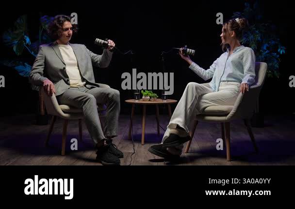In a stylish studio, two influencers engage in a lively interview ...