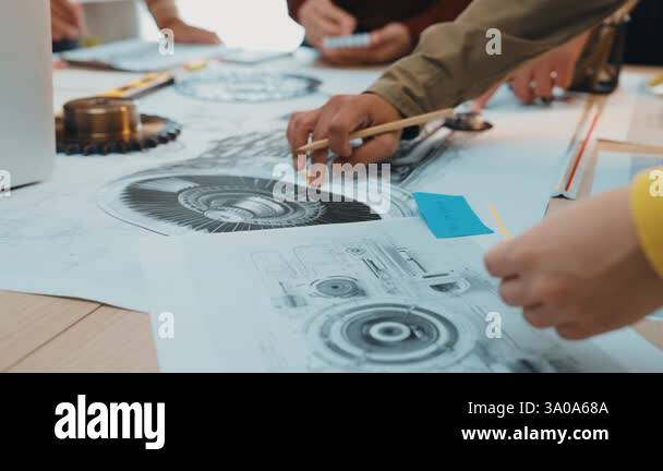 Engaging team members collaborate on technical drawings and sketches in ...