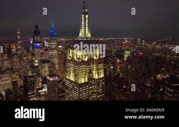 Nighttime aerial view showcasing the rooftop and spire of illuminated ...