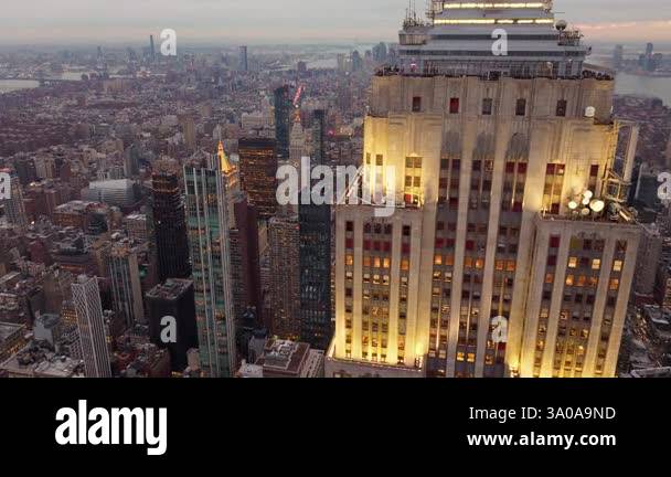 Empire State Building rooftop with visitors watching New York cityscape ...