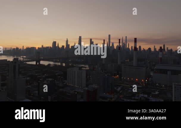 Warm sunlight illuminates iconic New York City skyline, seen from ...