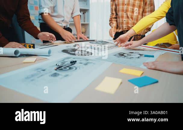 A diverse group of professionals collaborates on an engineering project ...