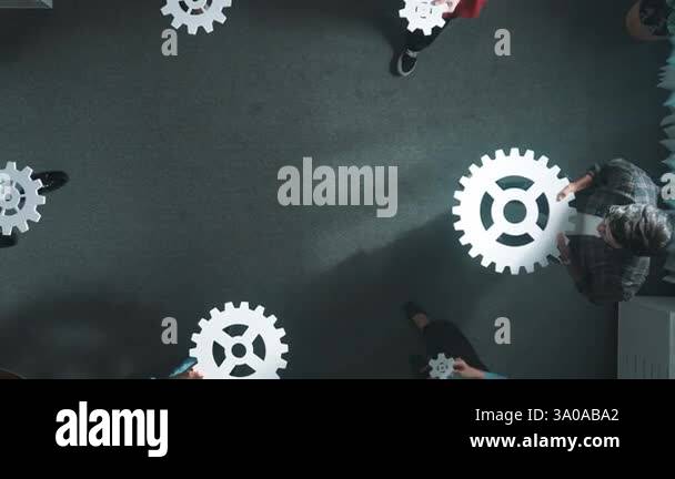 Top down aerial view of business team working together to gather cog ...