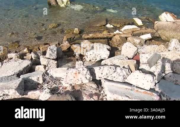 Upward tilted shot of stones on coastal beach with Sea of Cortez in ...