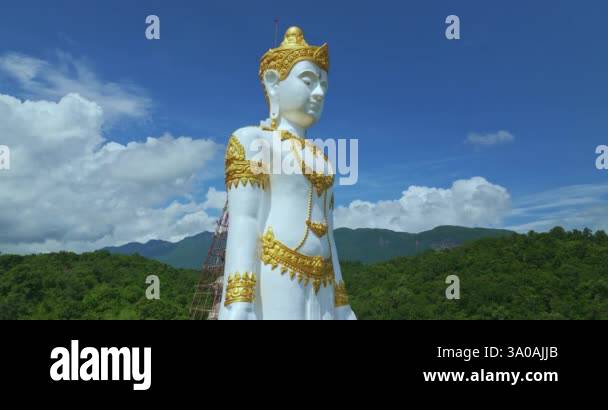 Close up the Tall Buddha Brahma Panyo statue standing tall in front of ...