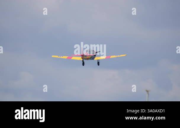 A propeller plane is taking off at the small airport. Cloudy sky ...