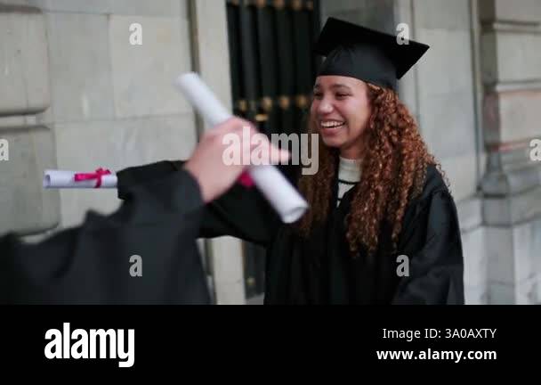 Two excited female graduates hugging and celebrating their academic ...