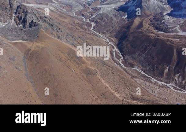 Aerial perspective gliding over snow crowned Himalayan peaks, revealing ...