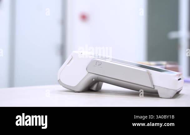 4k closeup video of Female hand with pos-terminal and cellphone. Pay by ...